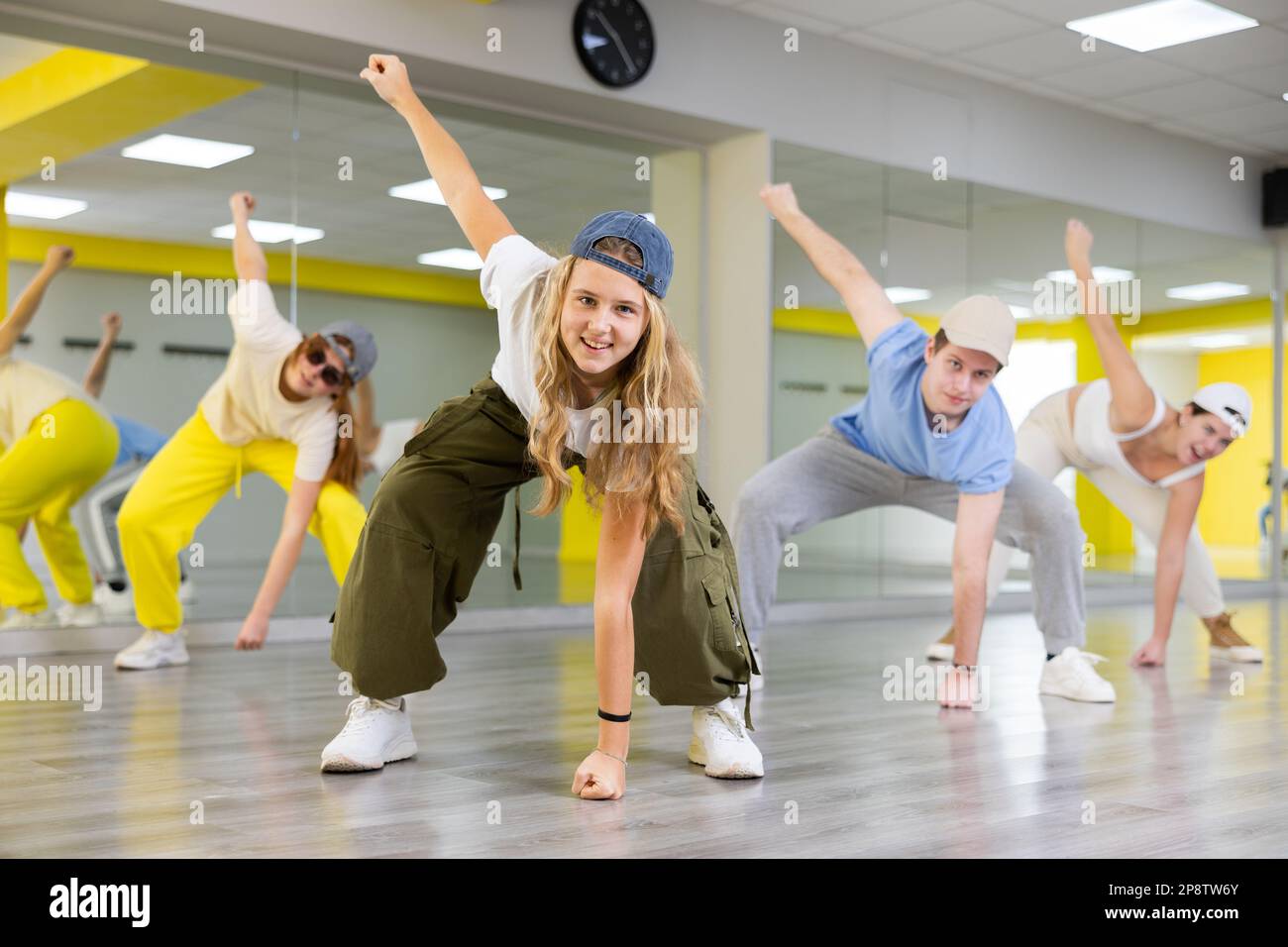 Teenage girl training breakdance drops in dance hall Stock Photo - Alamy