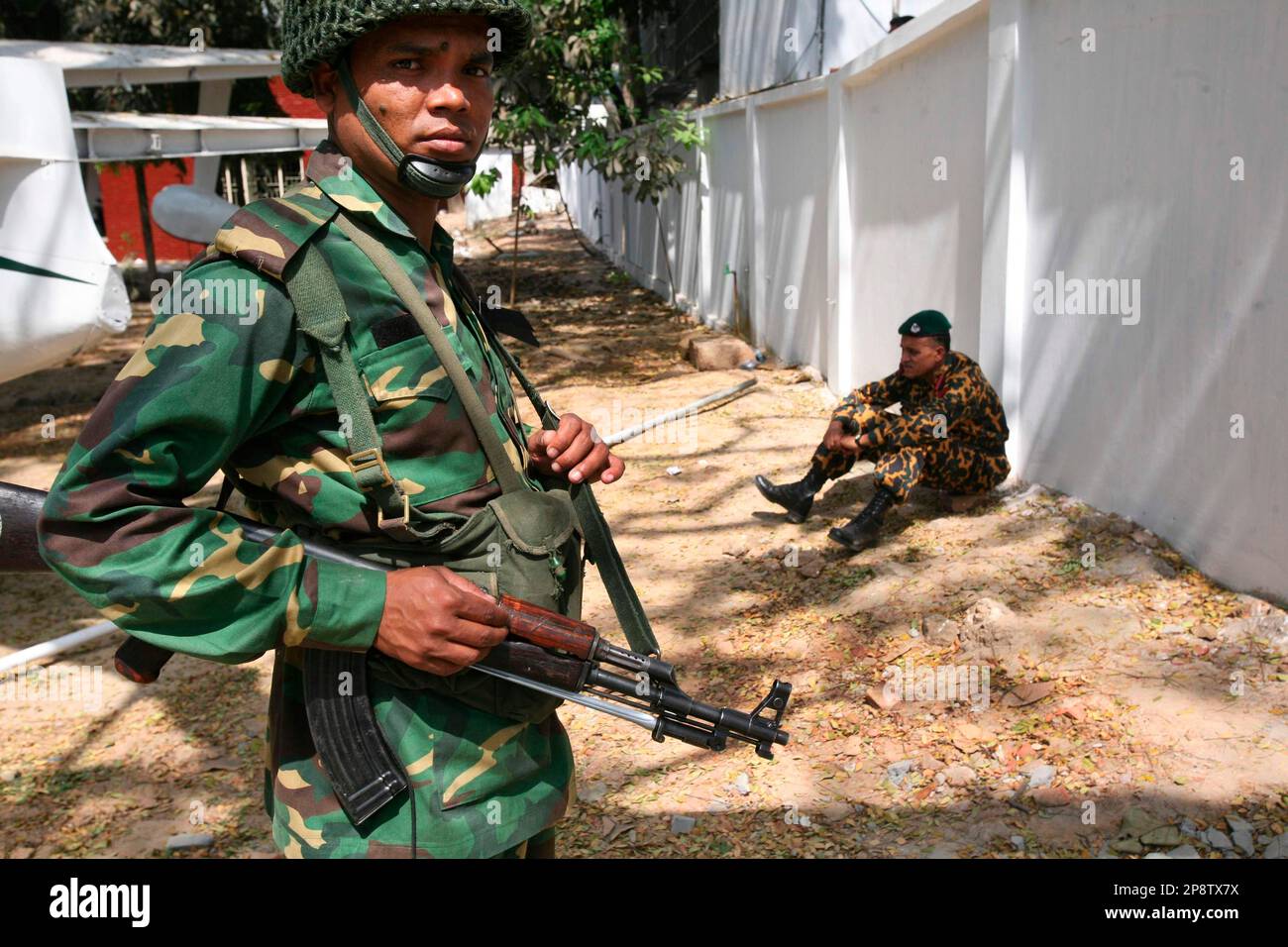 An army soldier in green uniform stands guard as a Bangladeshi border ...