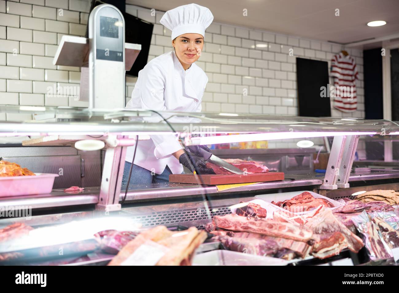 Woman cuts meat pieces hi-res stock photography and images - Alamy