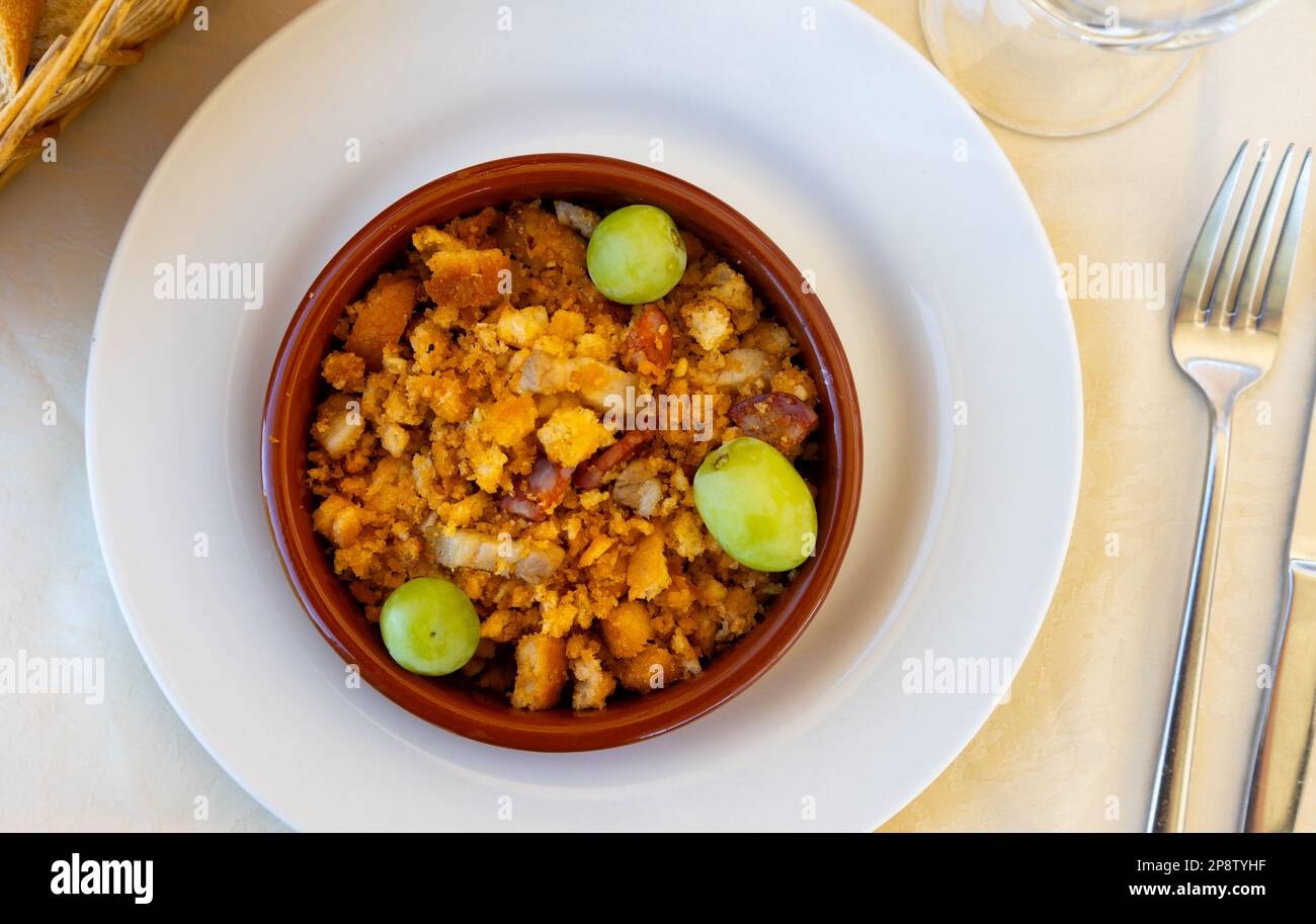 Plate with typical spanish dish migas pastoriles. Spanish cuisine Stock ...