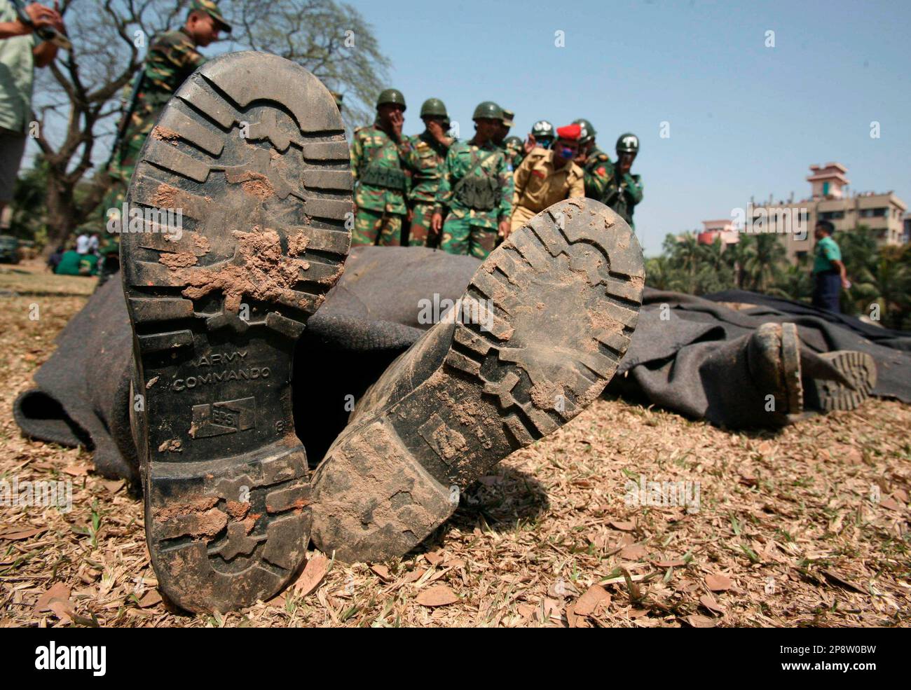 A group of Bangladesh army soldiers, background, try to recognize the ...