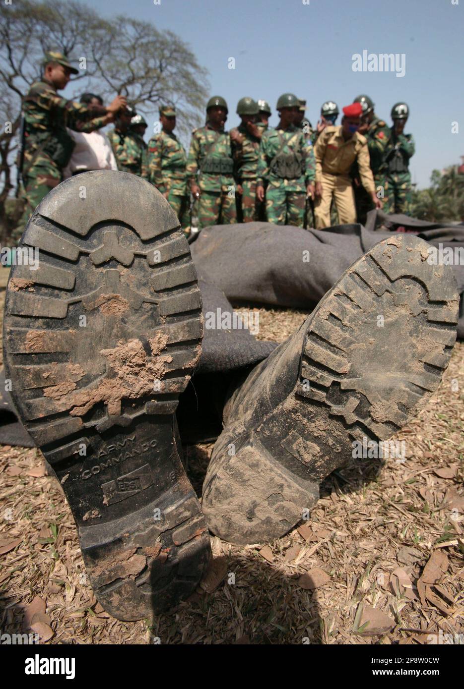 A group of Bangladesh army soldiers, background, try to recognize the ...