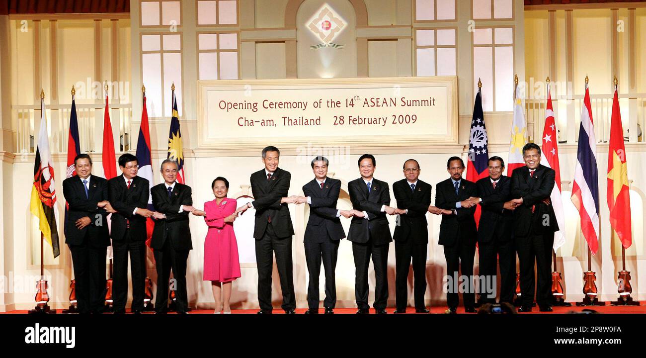 ASEAN leaders join in a traditional handshake during opening ceremonies ...