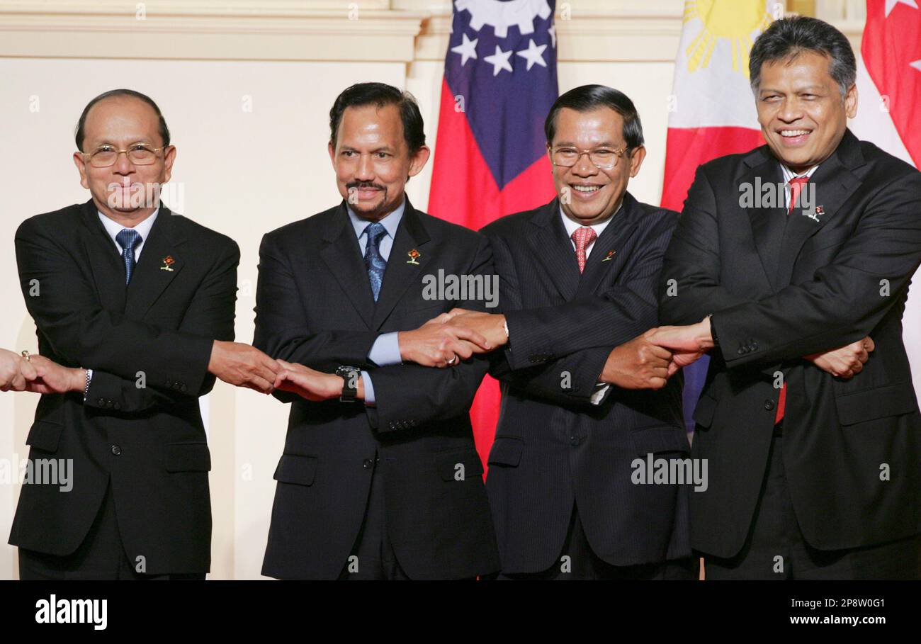 ASEAN leaders join in a traditional handshake during opening ceremonies ...