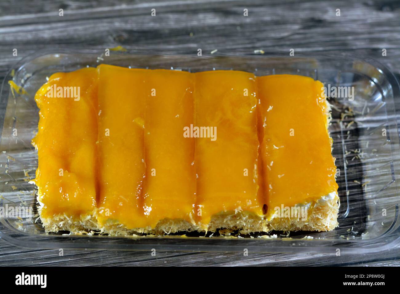 Konafa covered with mango compote and stuffed with whipped cream and ...