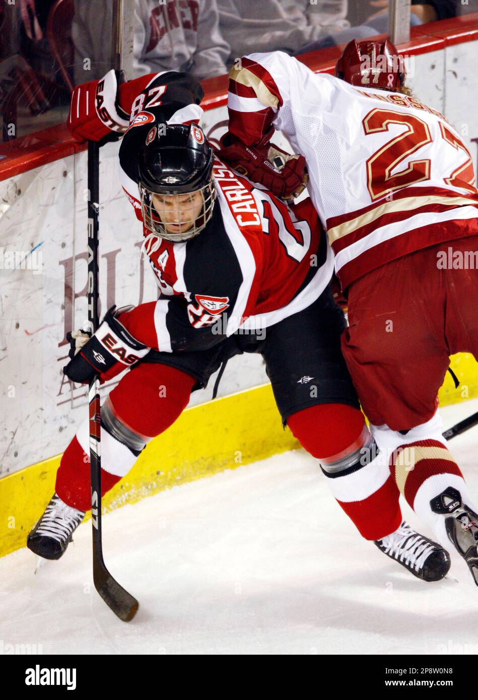St. Cloud State defenseman David Carlisle, left, skates around Denver's ...