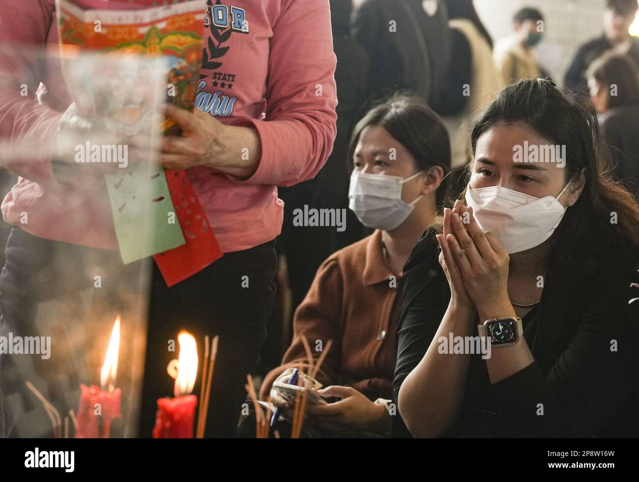 People perform a 'villain hitting' ceremony under the Canal Road ...