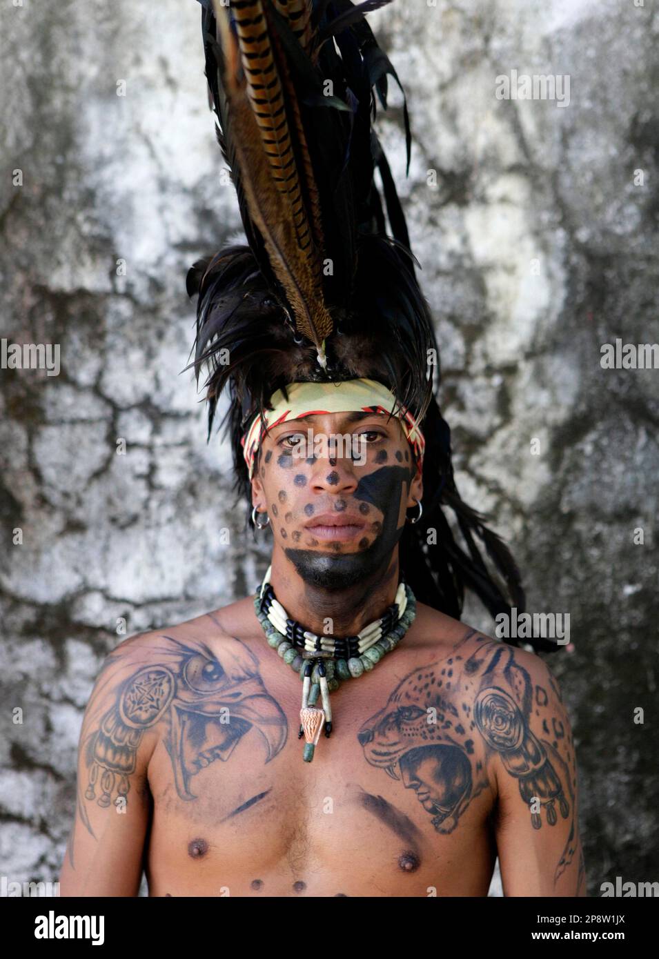 An Aztec dancer poses for a photo during a ceremony celebrating the ...
