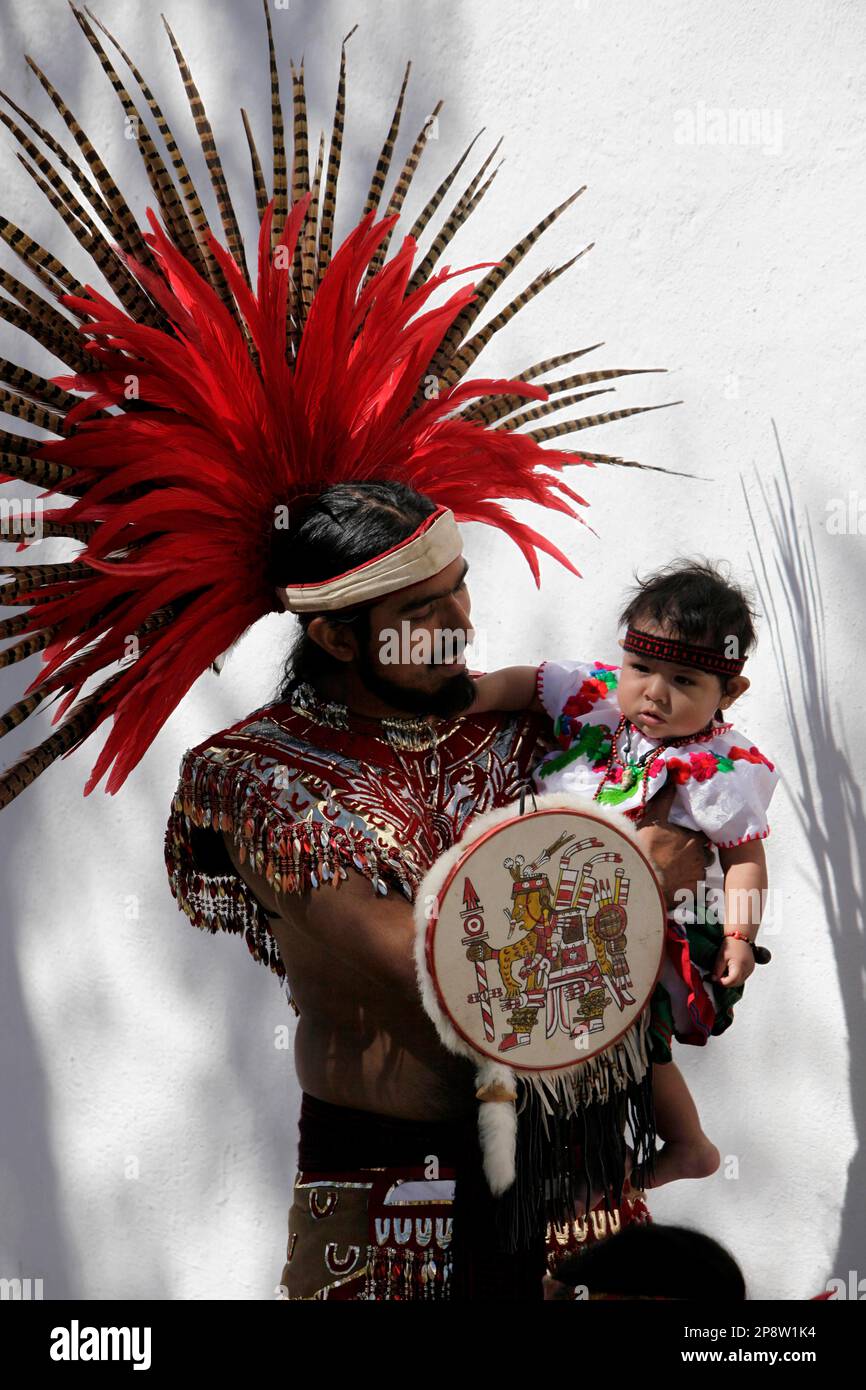 An Aztec dancer poses for a photo during a ceremony celebrating the ...