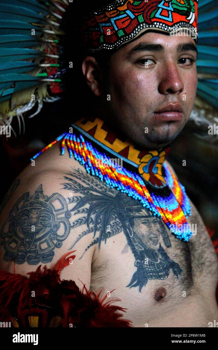 An Aztec dancer poses for a photo during a ceremony celebrating the ...