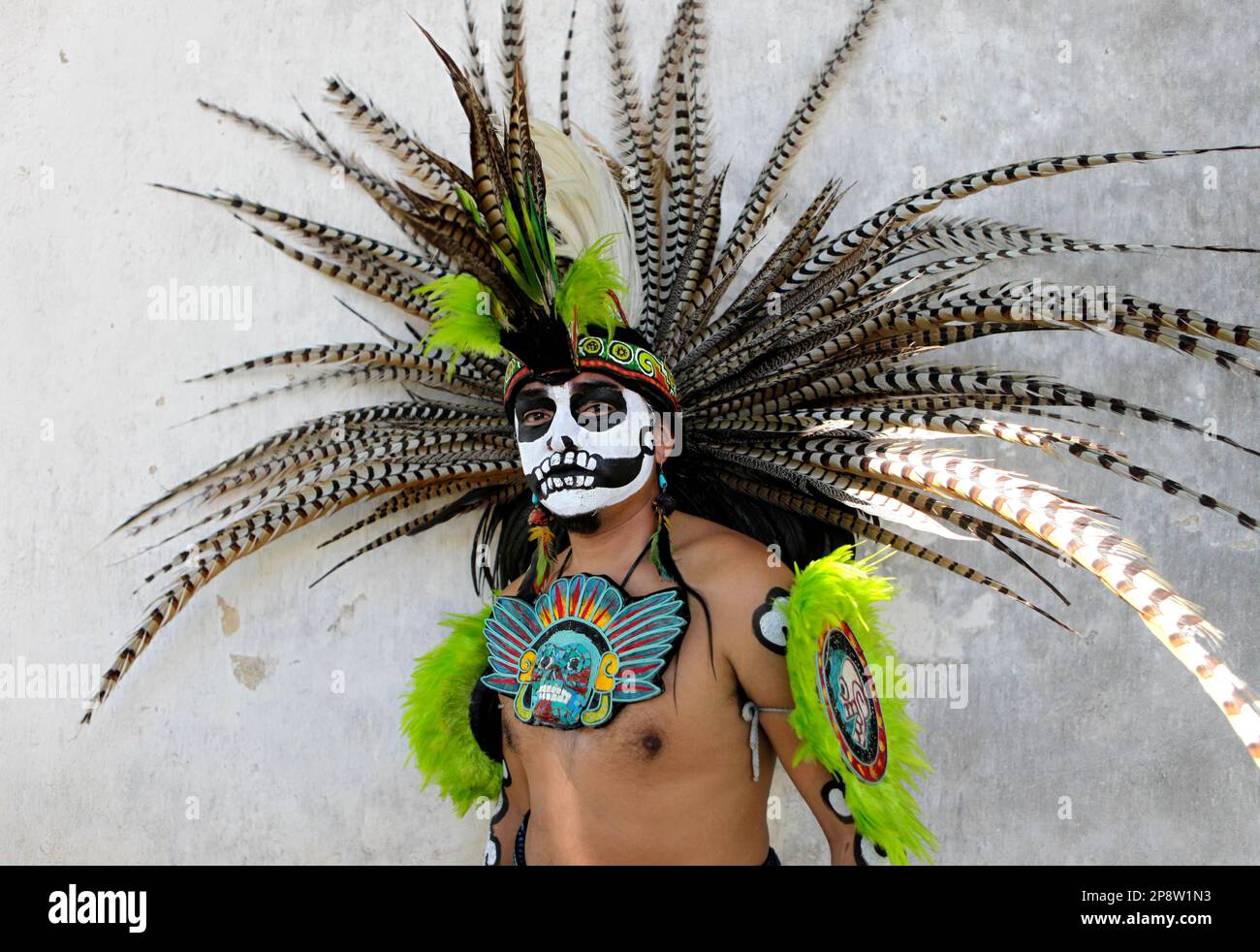 An Aztec dancer poses for a photo during a ceremony celebrating the ...