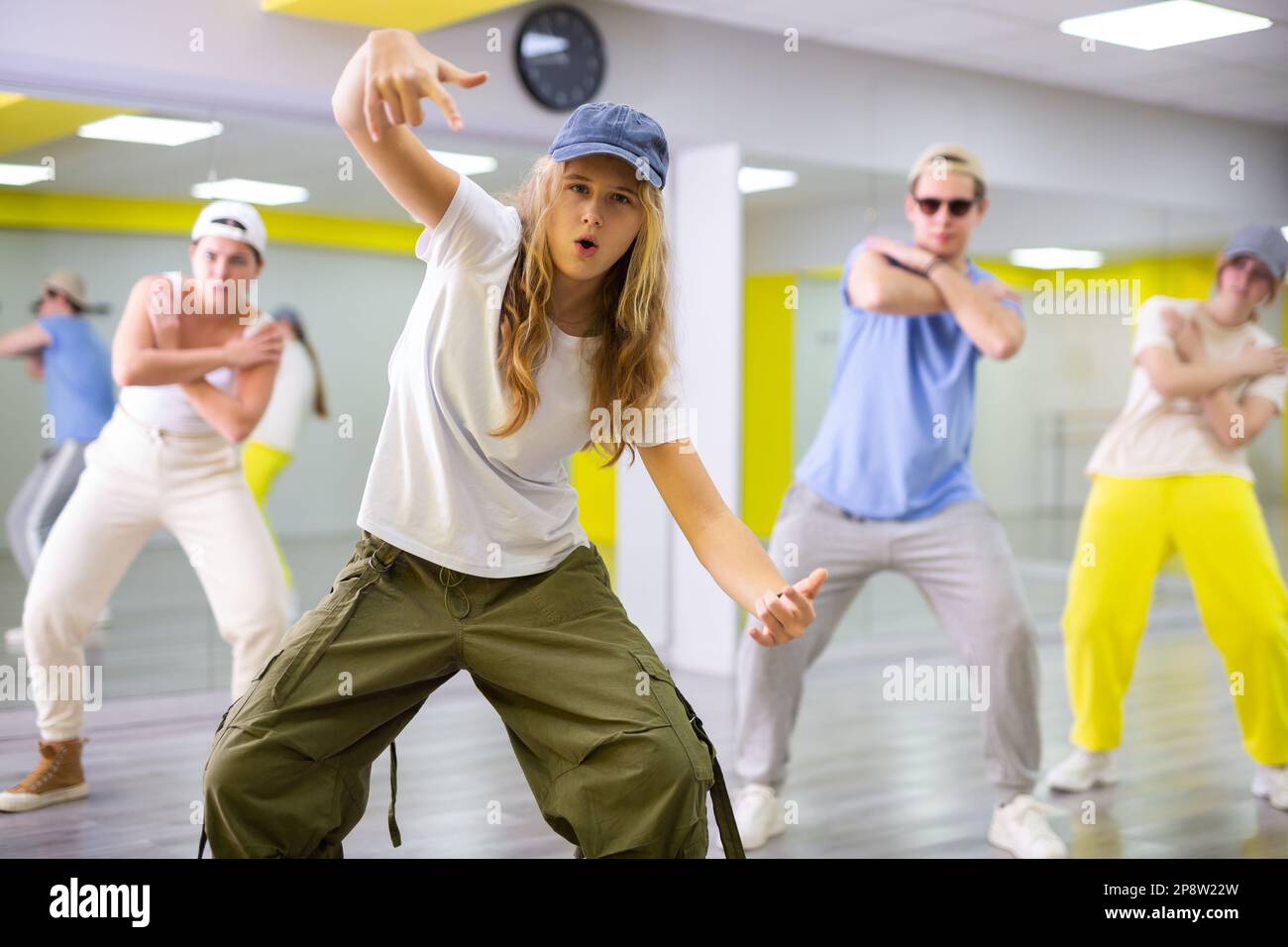 Teen girl in cap dancing modern dances Stock Photo - Alamy