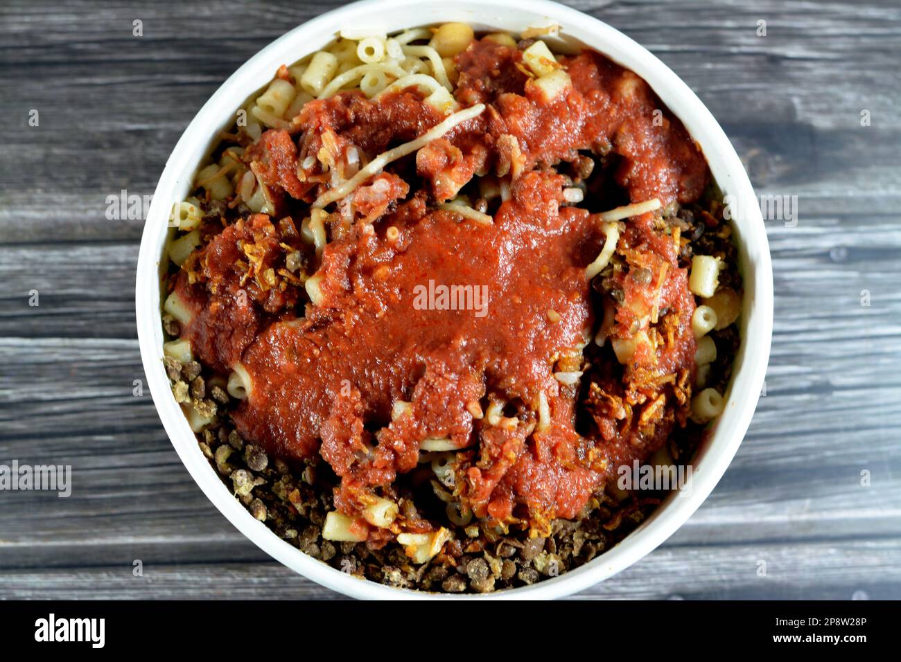 Egyptian cuisine of Koshary, a popular street food made of rice ...