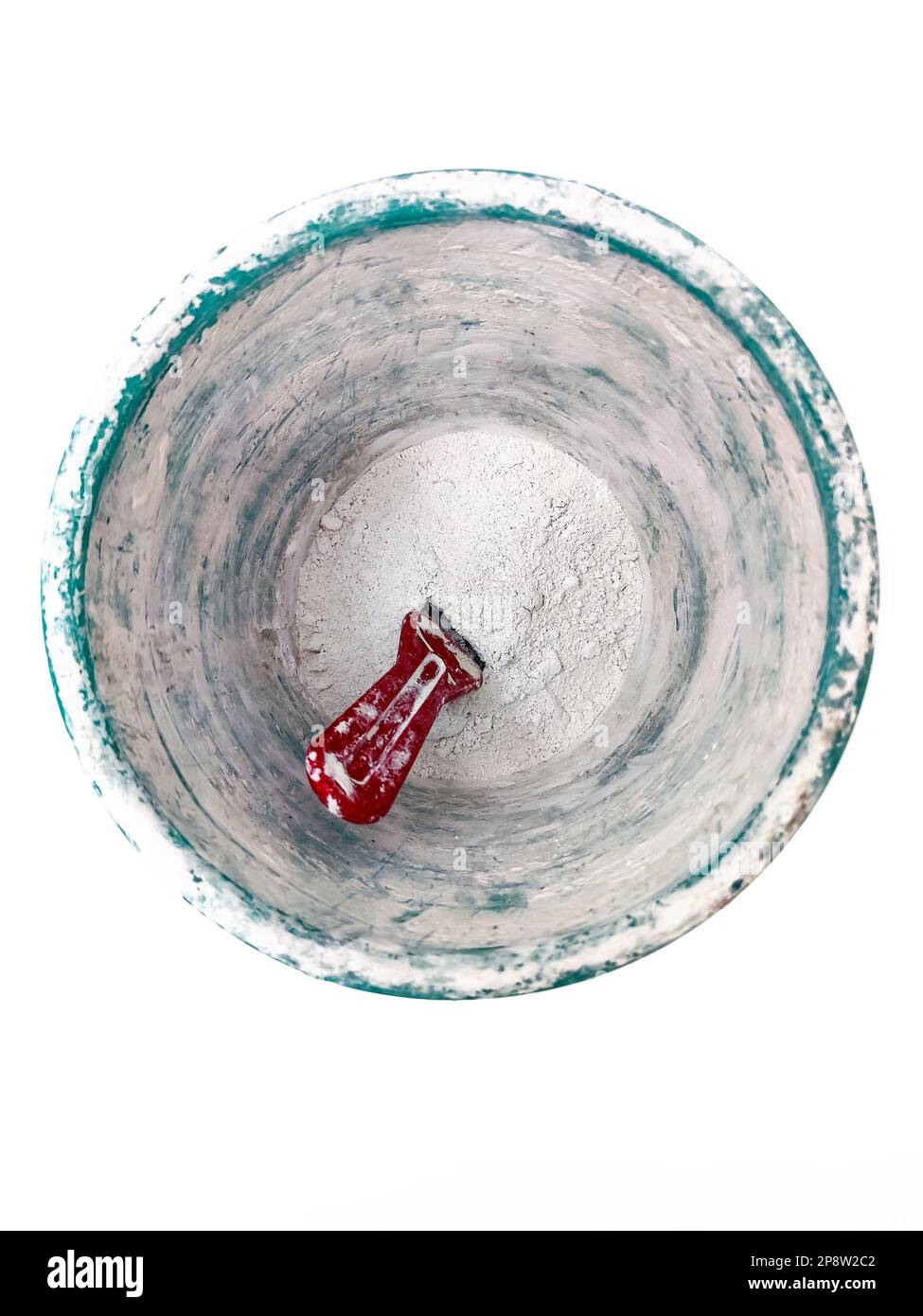 Spatula is placed inside an old plastic bucket. Process of manual ...