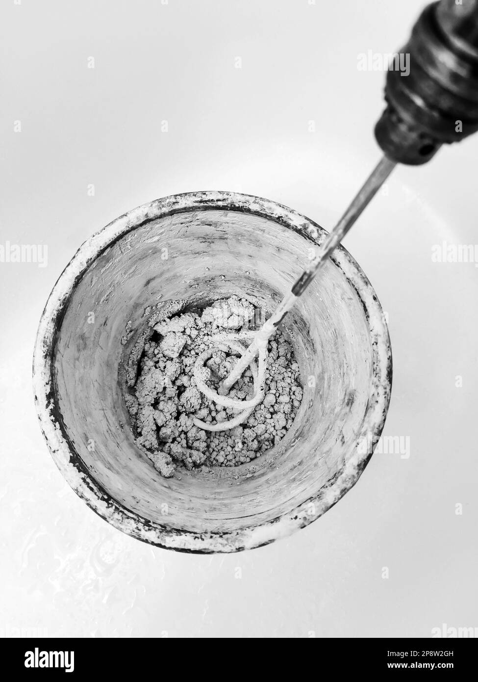 Mixer is placed inside an old plastic bucket. Process of manual mixing ...