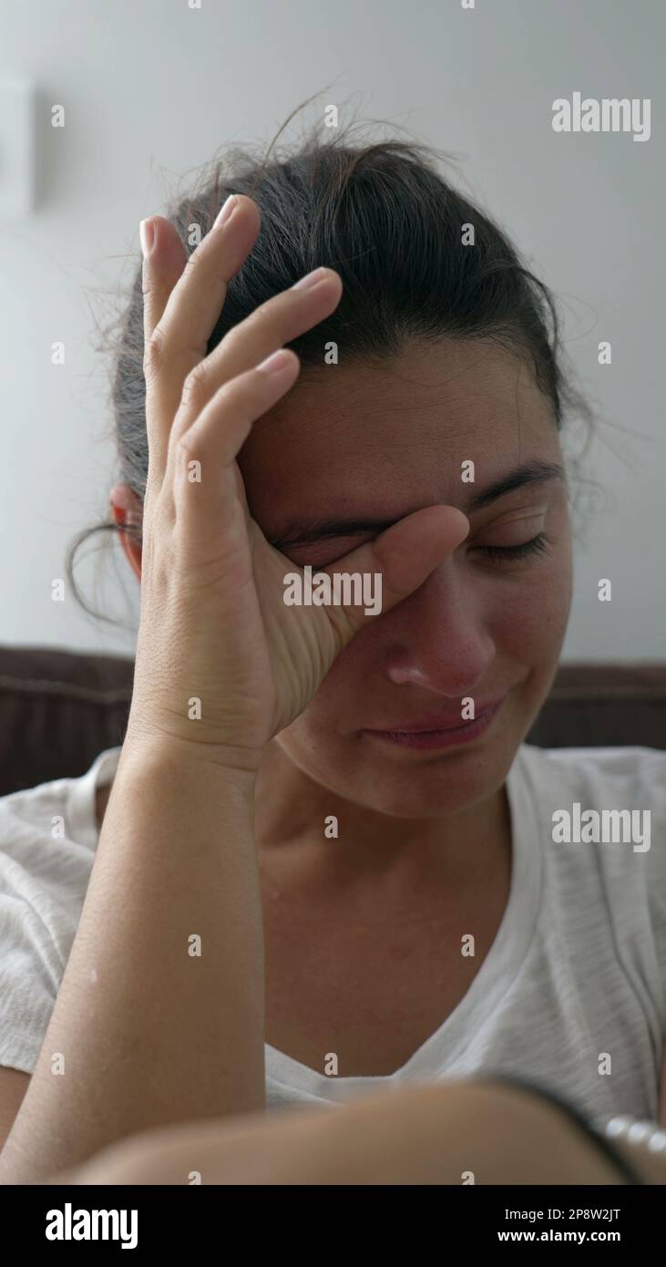 One tearful woman wiping tears. Crying female person going through hard ...