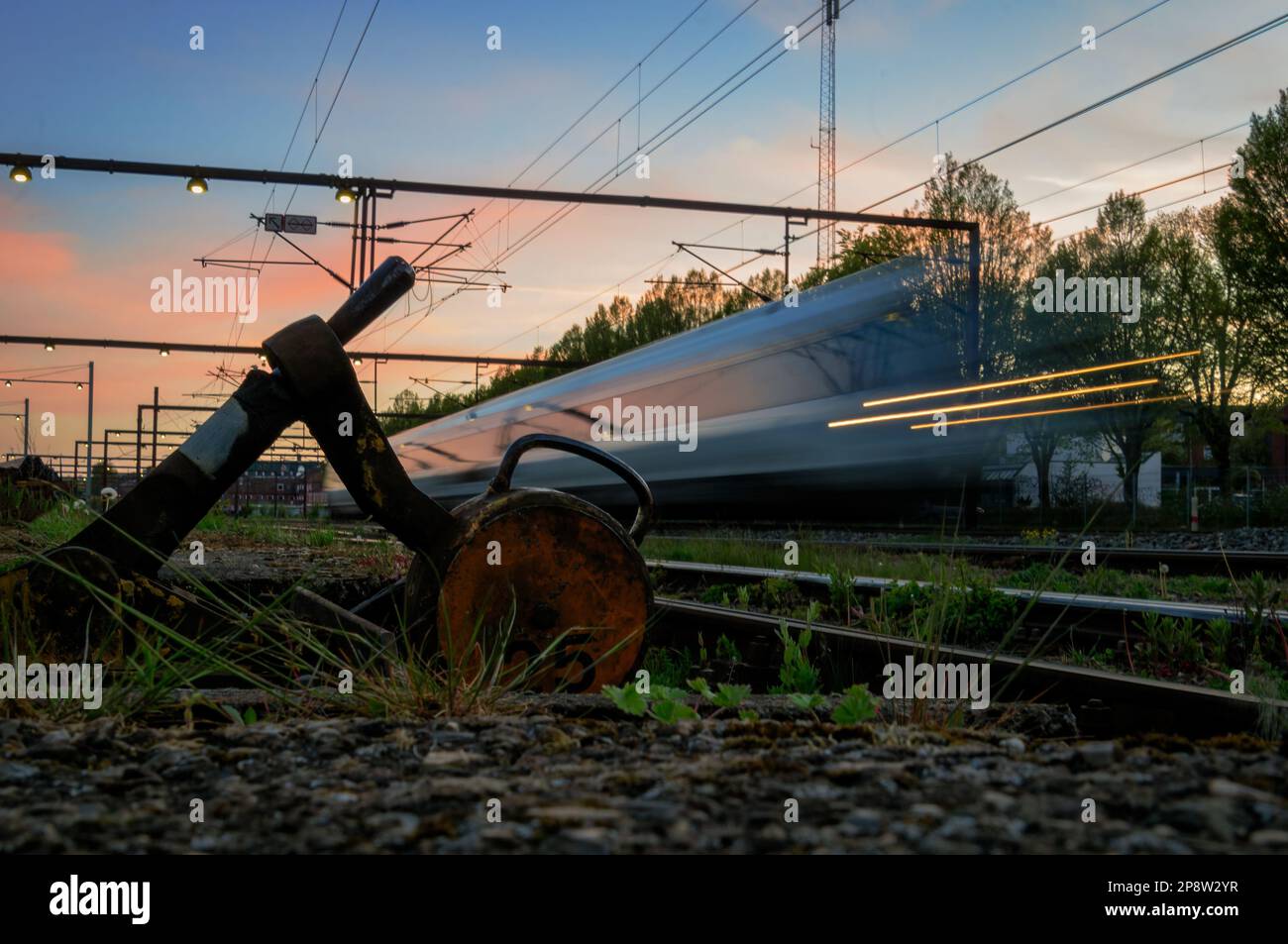 A vintage-style locomotive train chugging along railway tracks ...