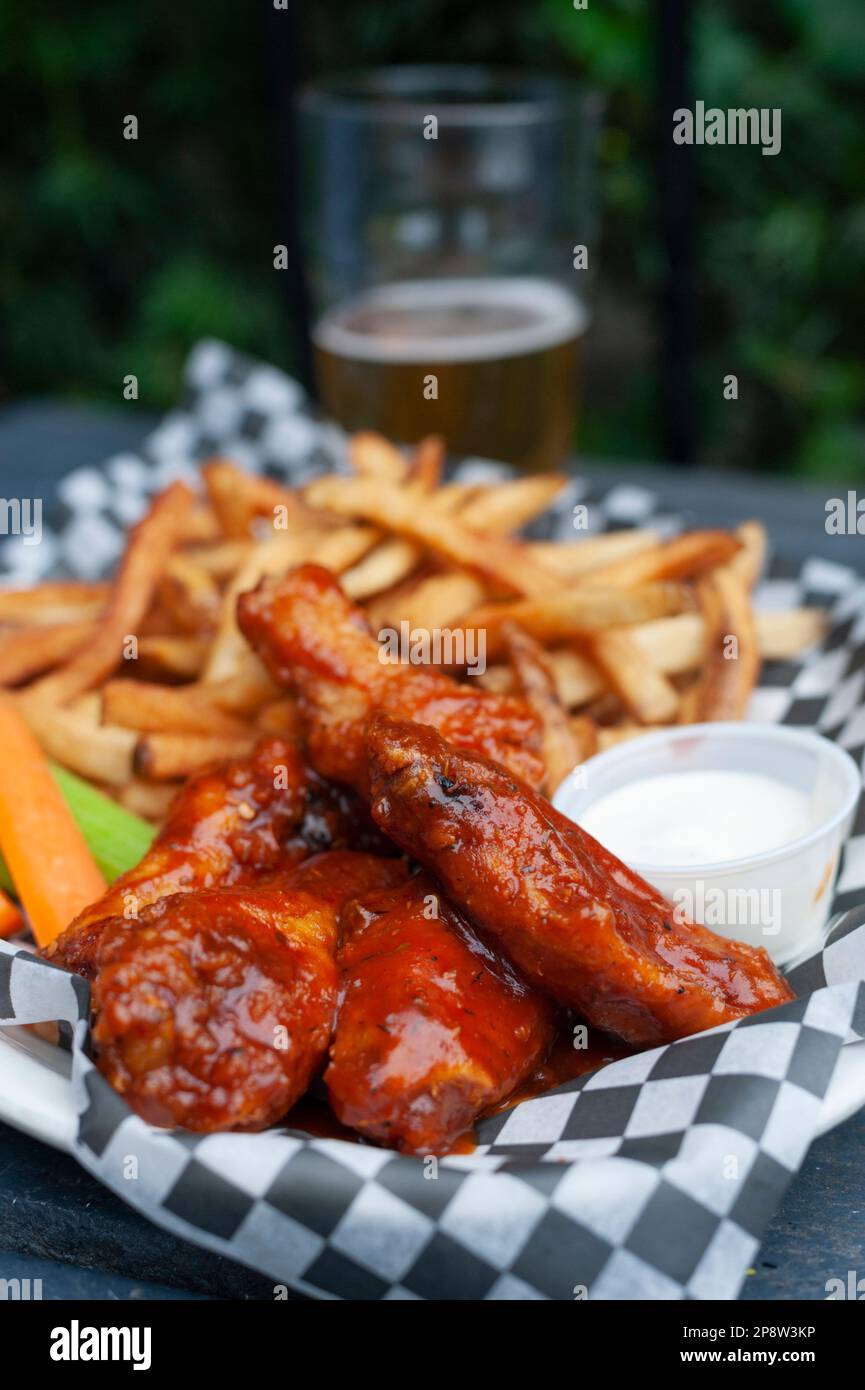 Chicken wings, served with fries and vegetable sticks with ranch ...