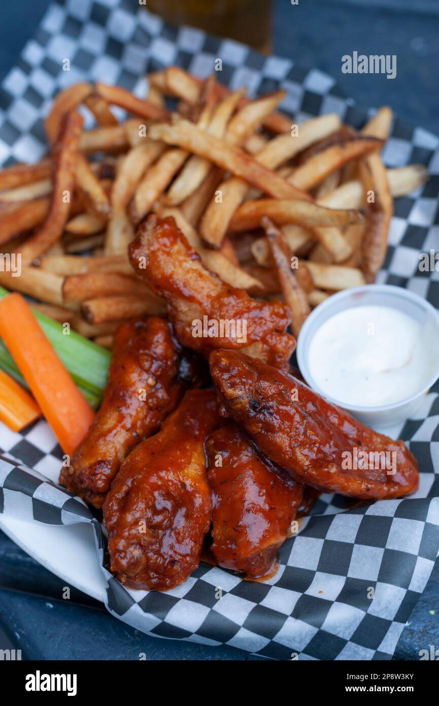 Chicken wings, served with fries and vegetable sticks with ranch ...
