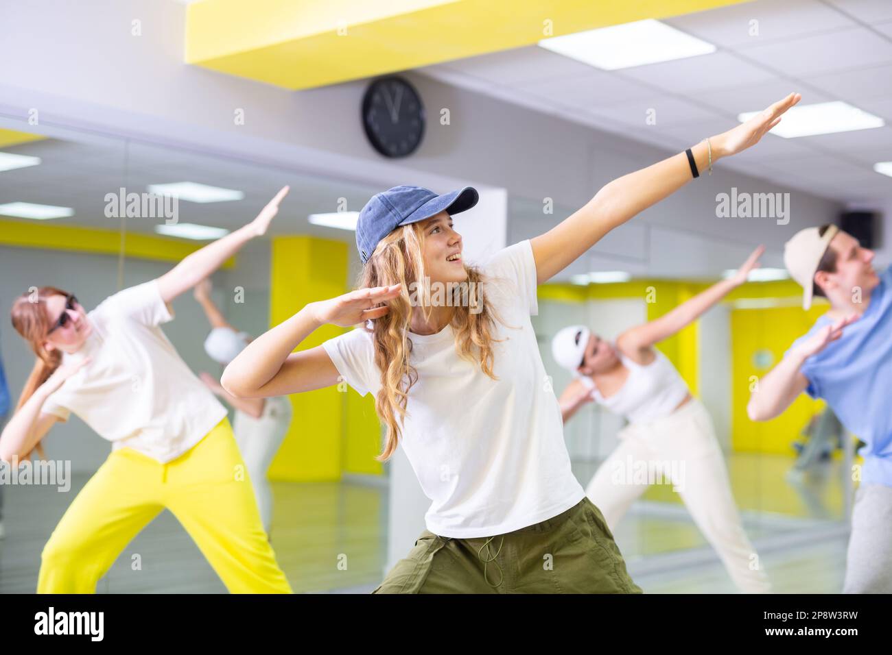 Teen girl in cap dancing modern dances Stock Photo - Alamy