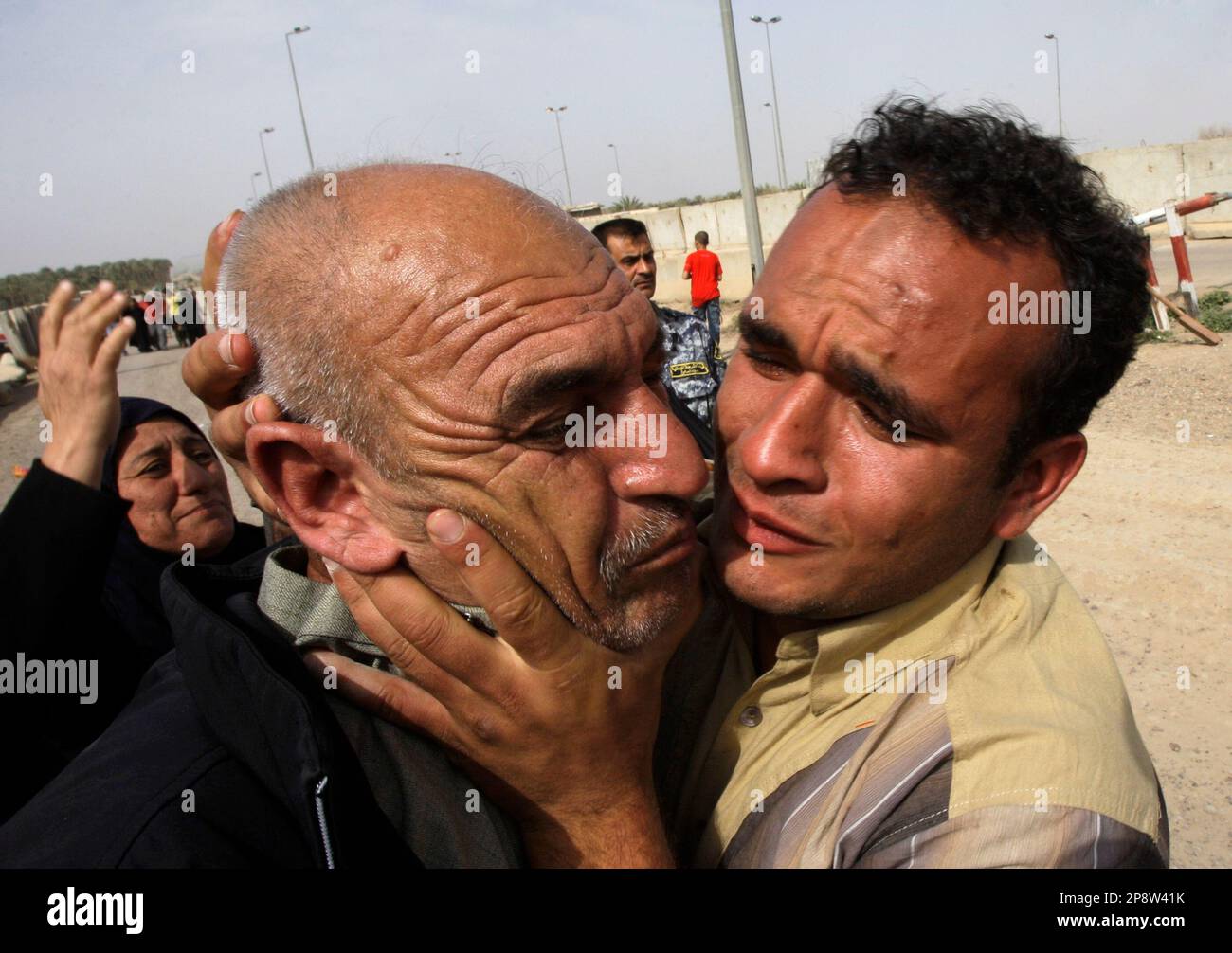 Sa'ad Karim, right, kisses his father after he was released from the U ...