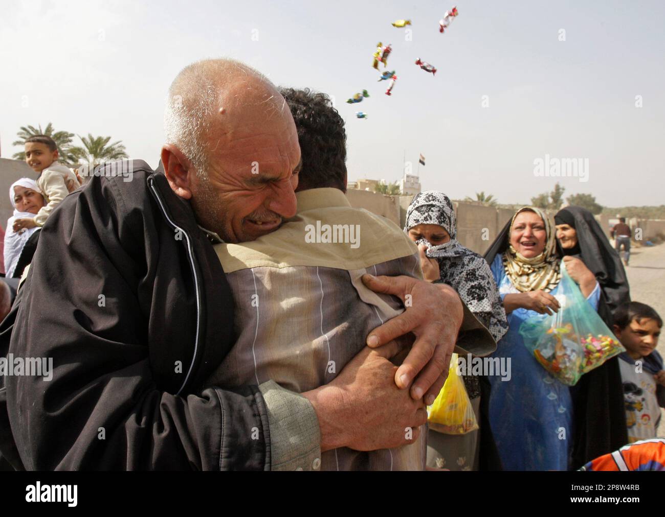 Ayad Abbas, right, hugs his son Fadil who was released from the U.S ...