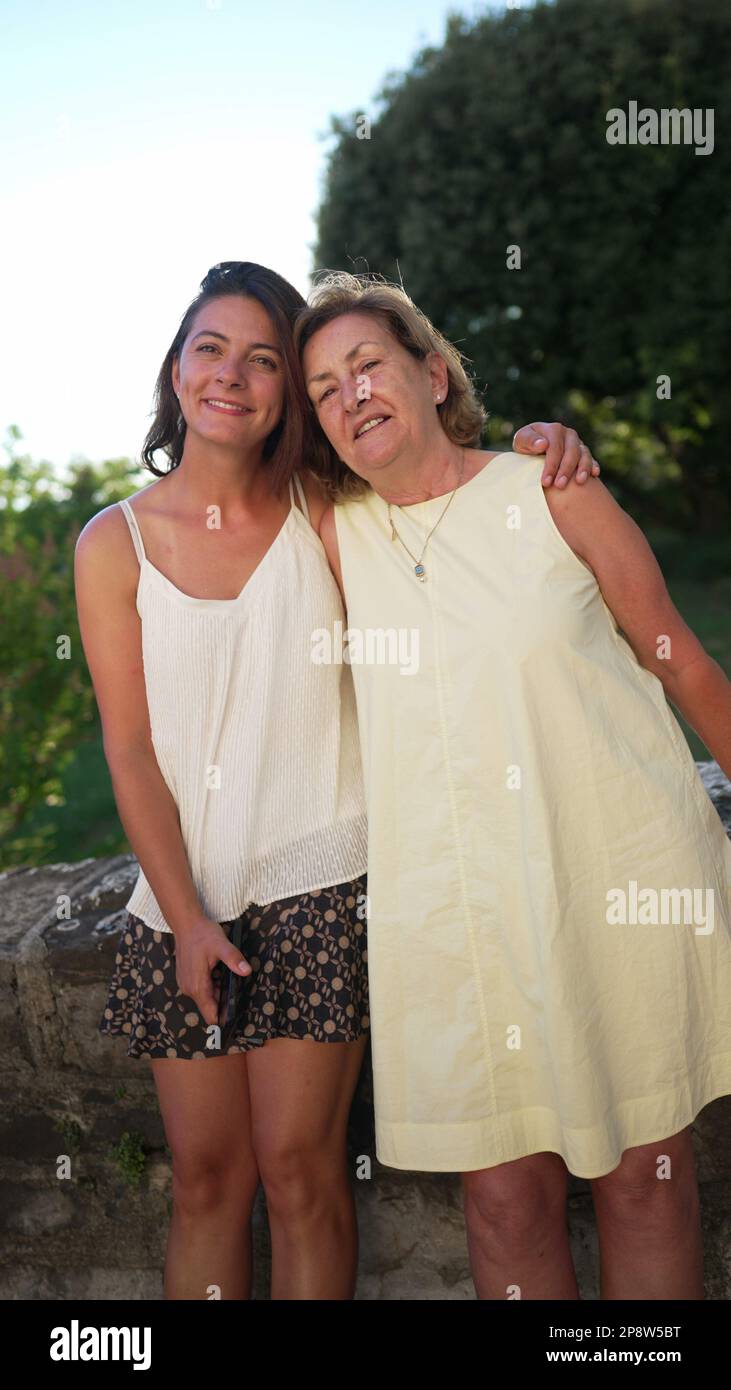 Adult daughter posing with senior mother outside. Happy people of ...