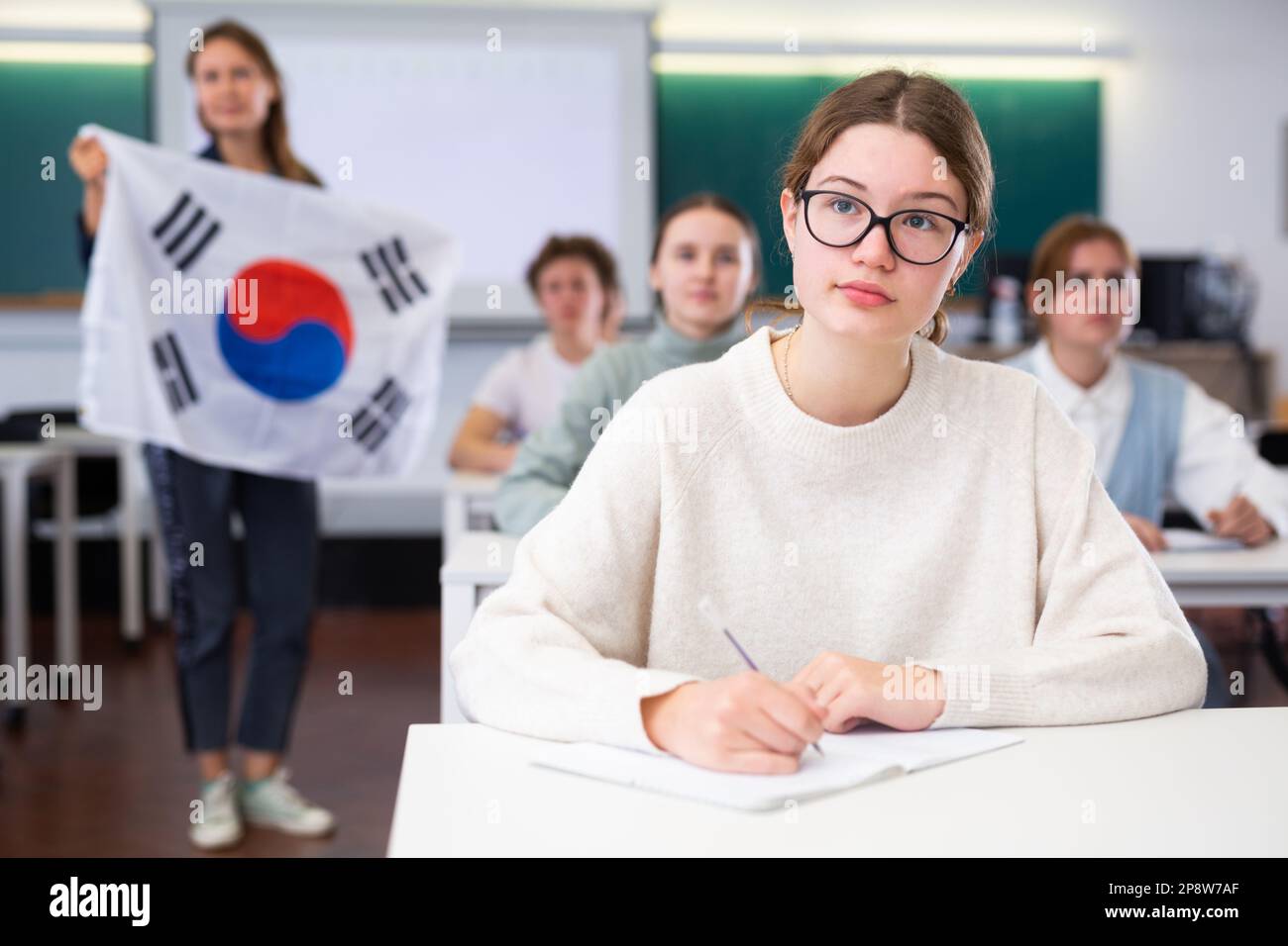 High school teacher holds the flag of South Korea in her hands and ...