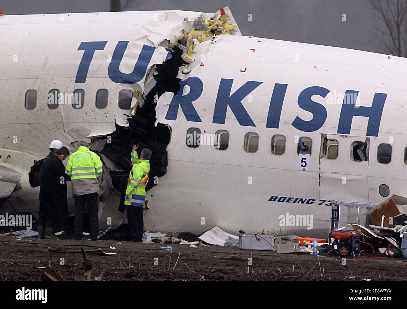 Rescue workers are seen near the wreckage of a Turkish Airlines ...