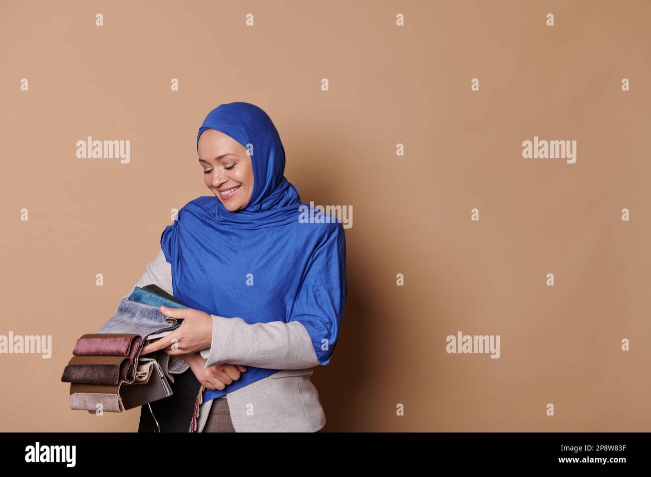 Multi-ethnic Muslim woman dressed in elegant gray suit and blue hijab ...
