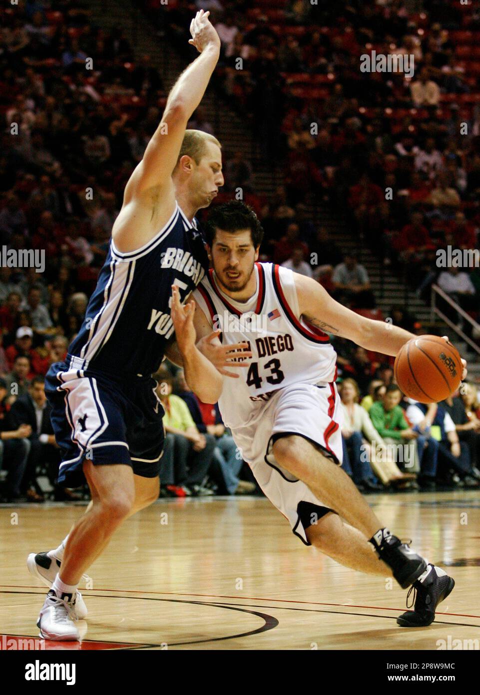 San Diego State's Ryan Amoroso, right, drives past the defense of ...