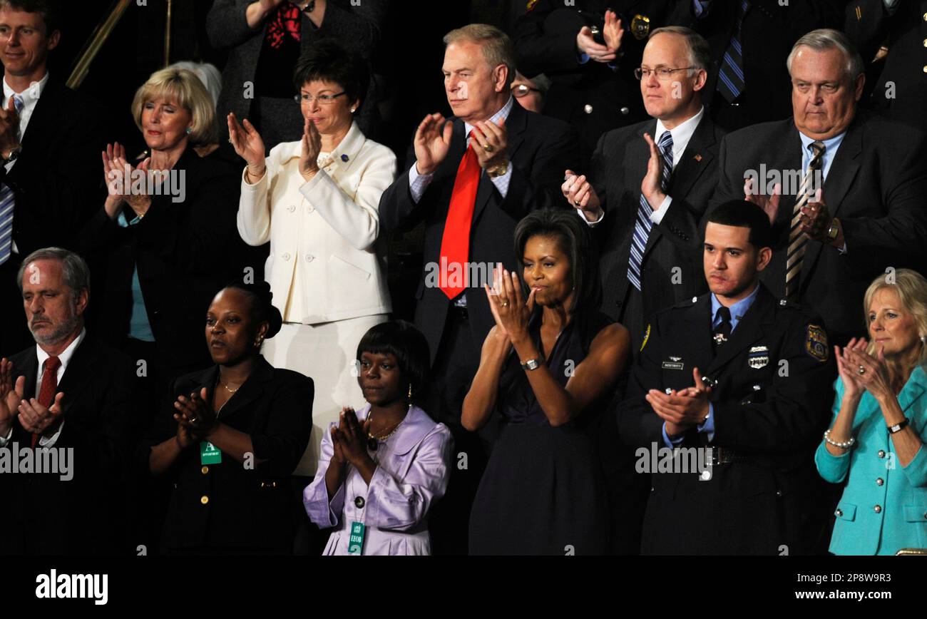 First lady Michelle Obama, center, and others applaud during President ...