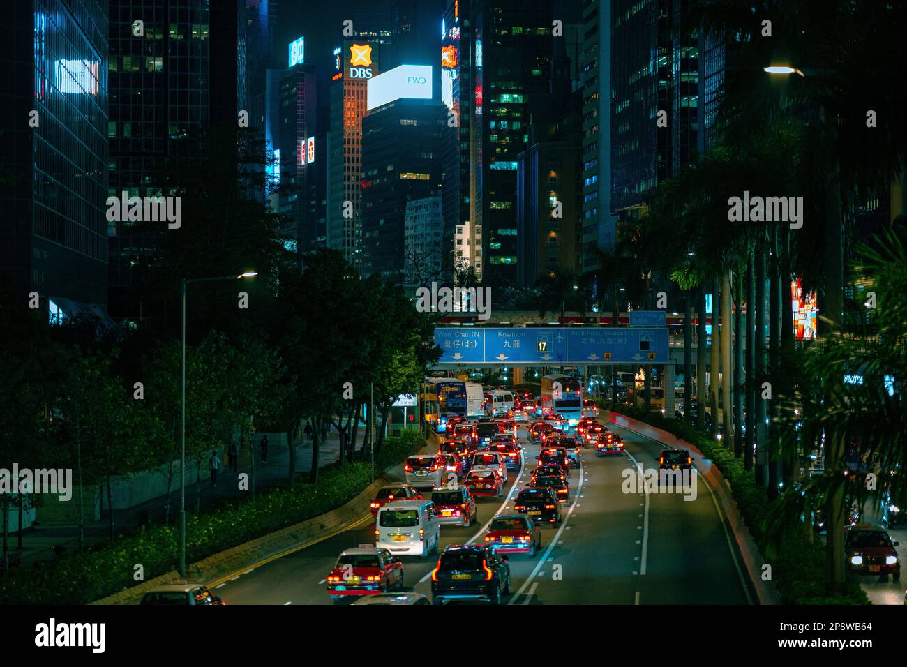 Brightly lit night scene of bustling traffic in a highway, with cars ...