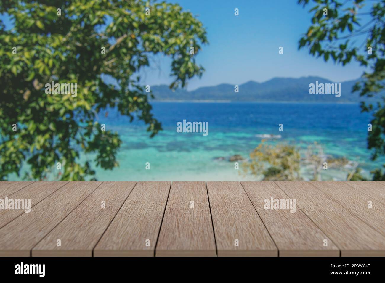 Wooden table with view of beautiful beach and sea with turquoise water ...