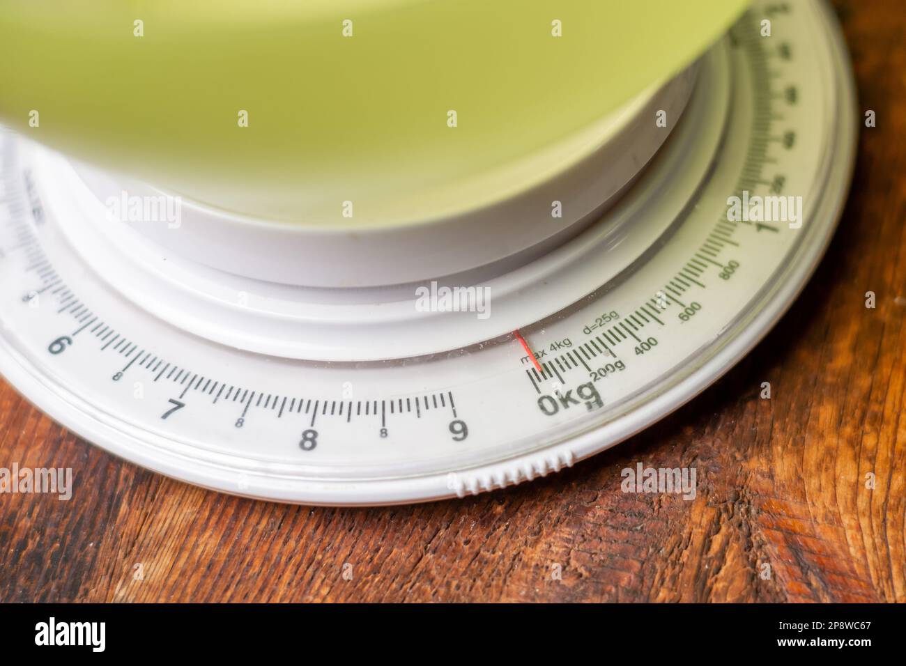 mechanical kitchen scales on wooden background. Measurement of weight of products for cooking ...