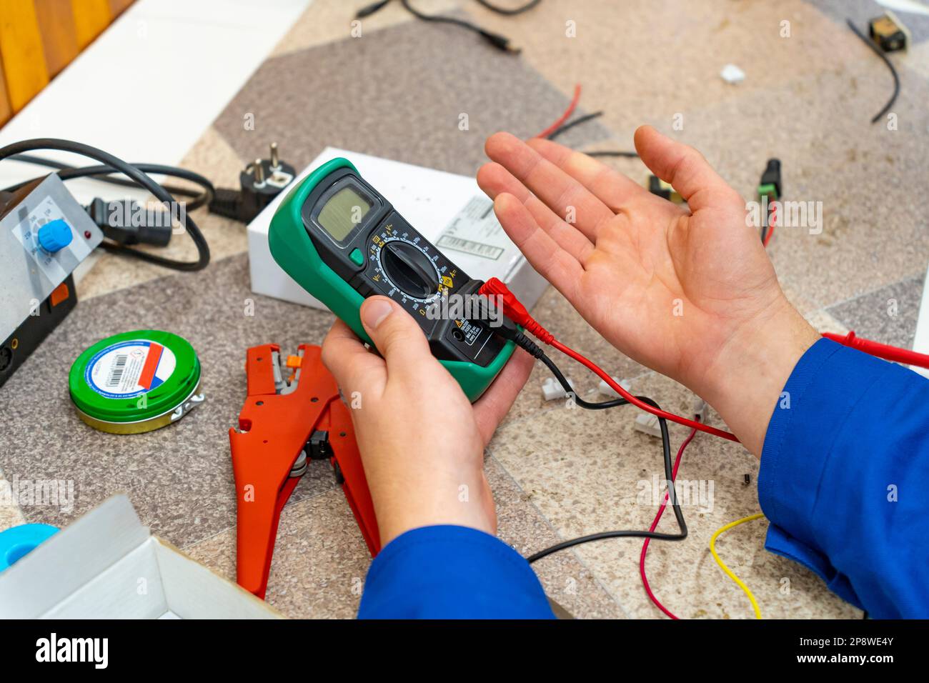 A voltage meter during electronic assembly Stock Photo - Alamy