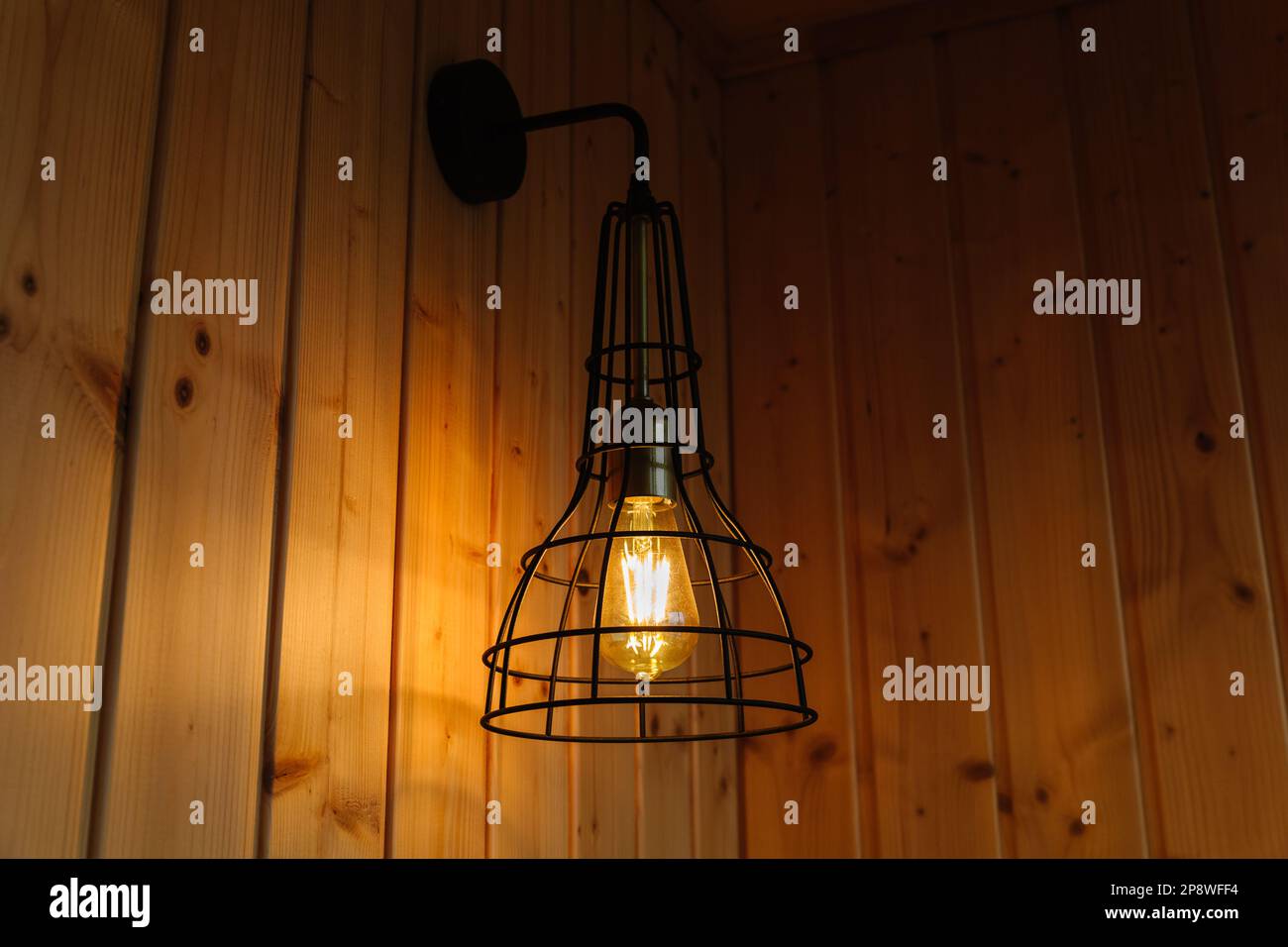 Stylish scandinavian composition of black bra with vintage edison lamp ...