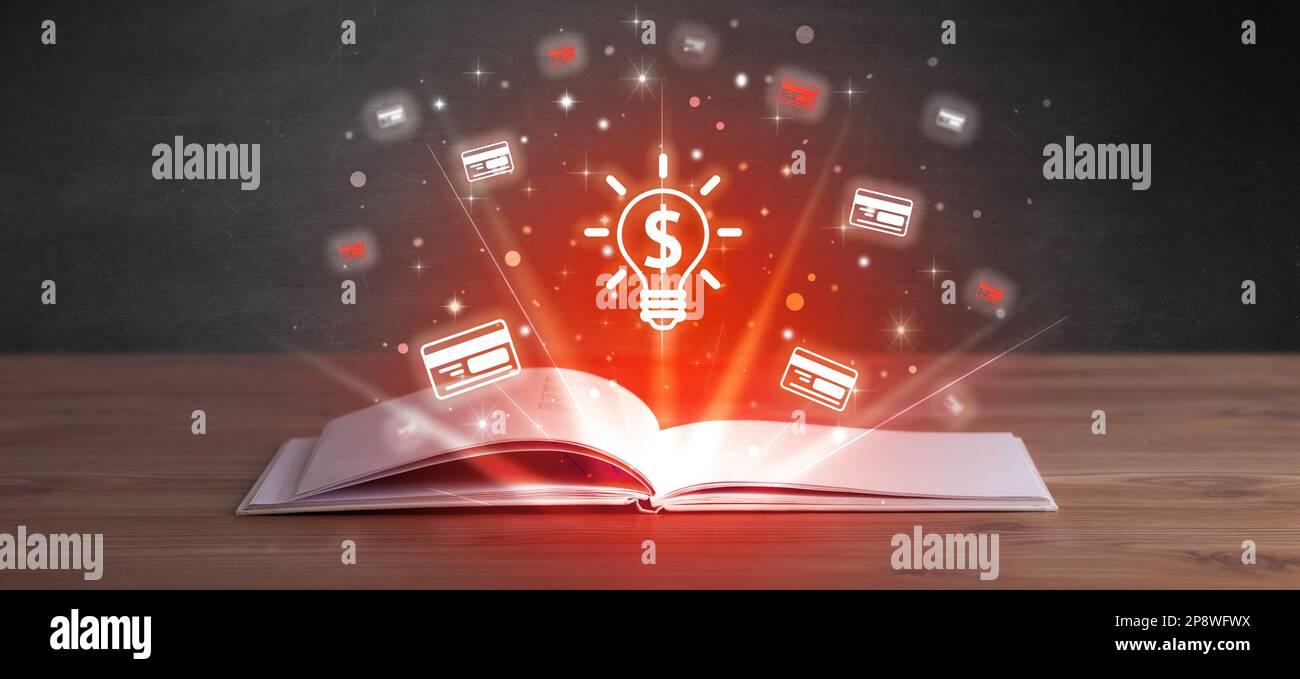 Open book with currency icons above Stock Photo - Alamy