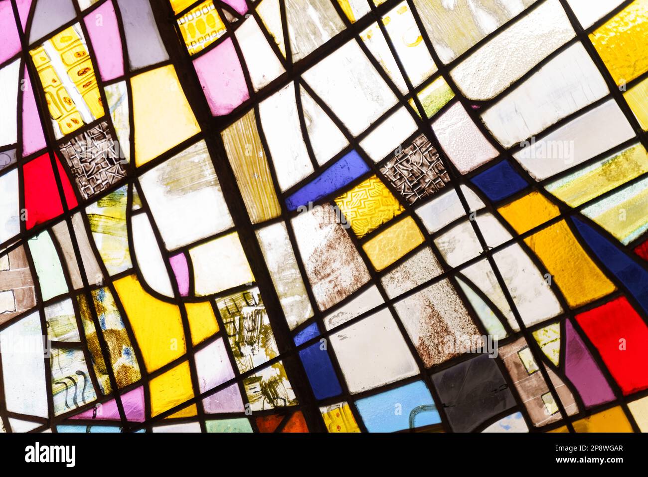 The texture of a glass stained glass window with shades of yellow, blue ...