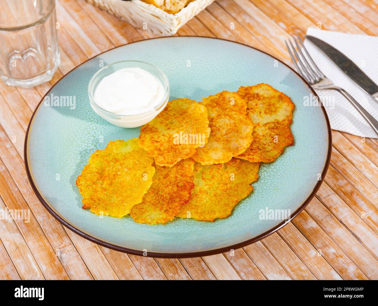 Draniki with sour cream at plate, dish of Belarusian cuisine Stock ...