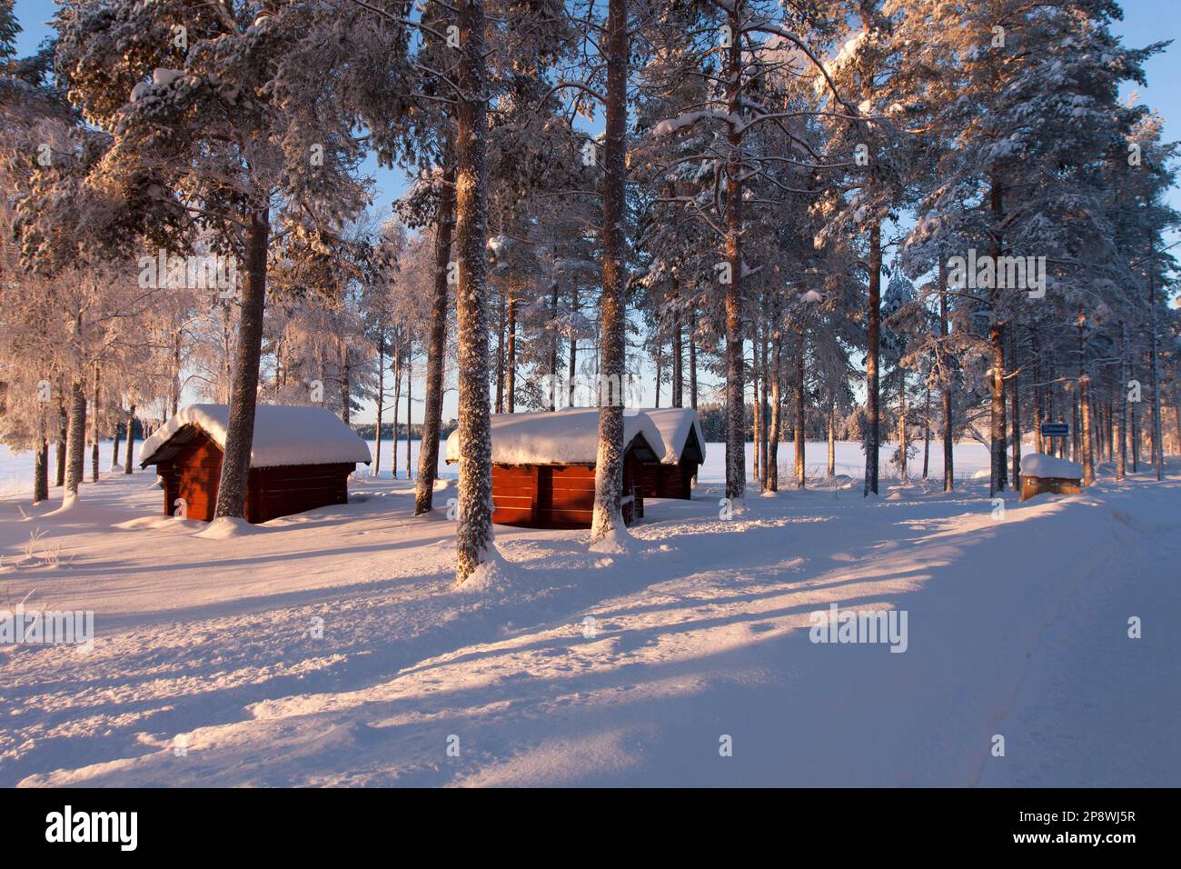 Small red buildings along a winter road. Public service area along a ...