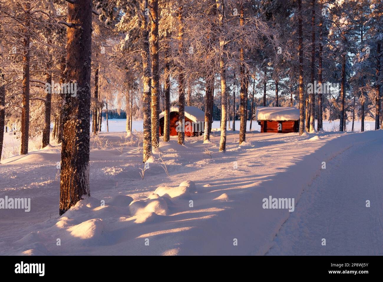Small red buildings along a winter road. Public service area along a ...