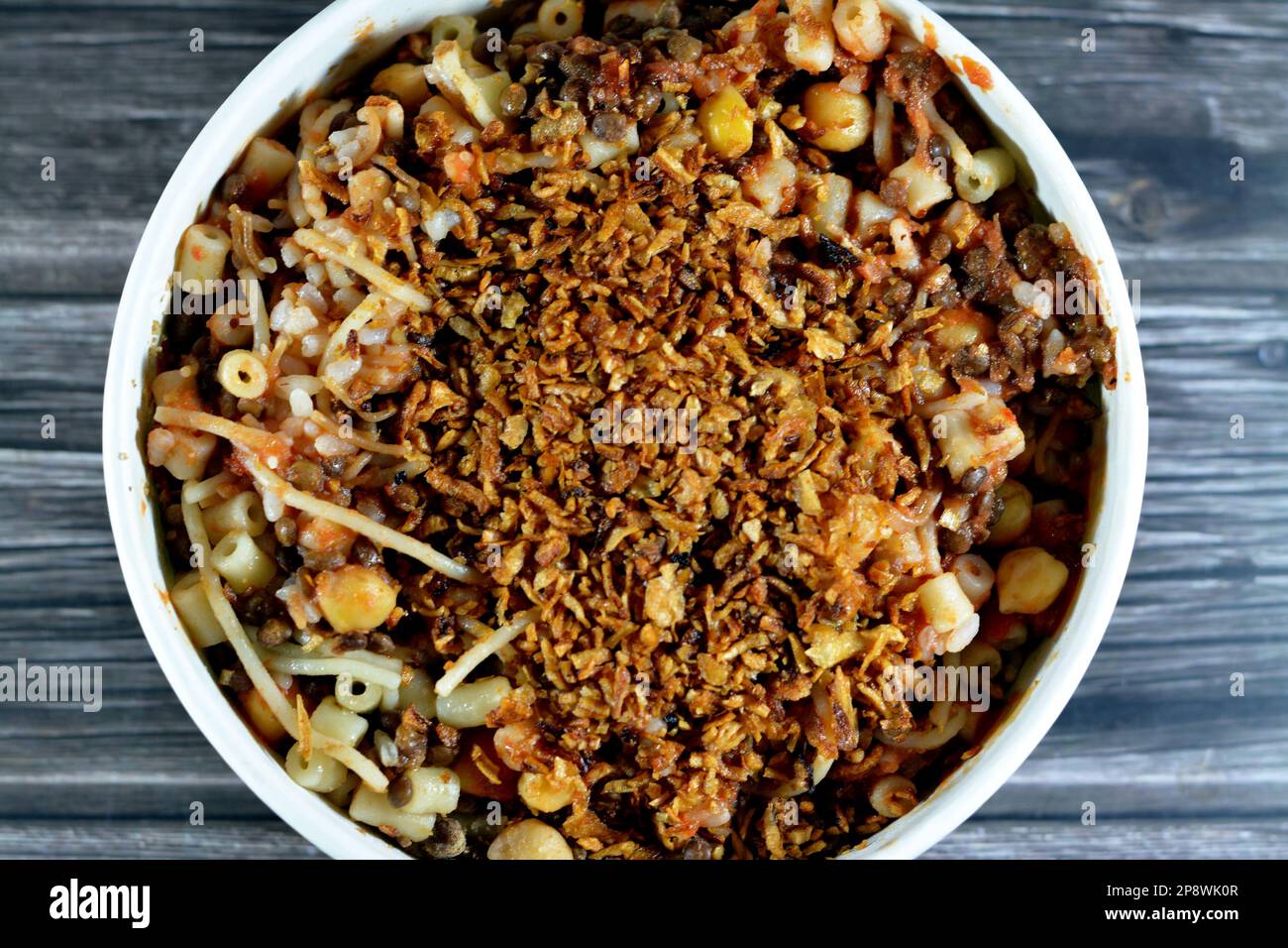 Egyptian cuisine of Koshary, a popular street food made of rice ...