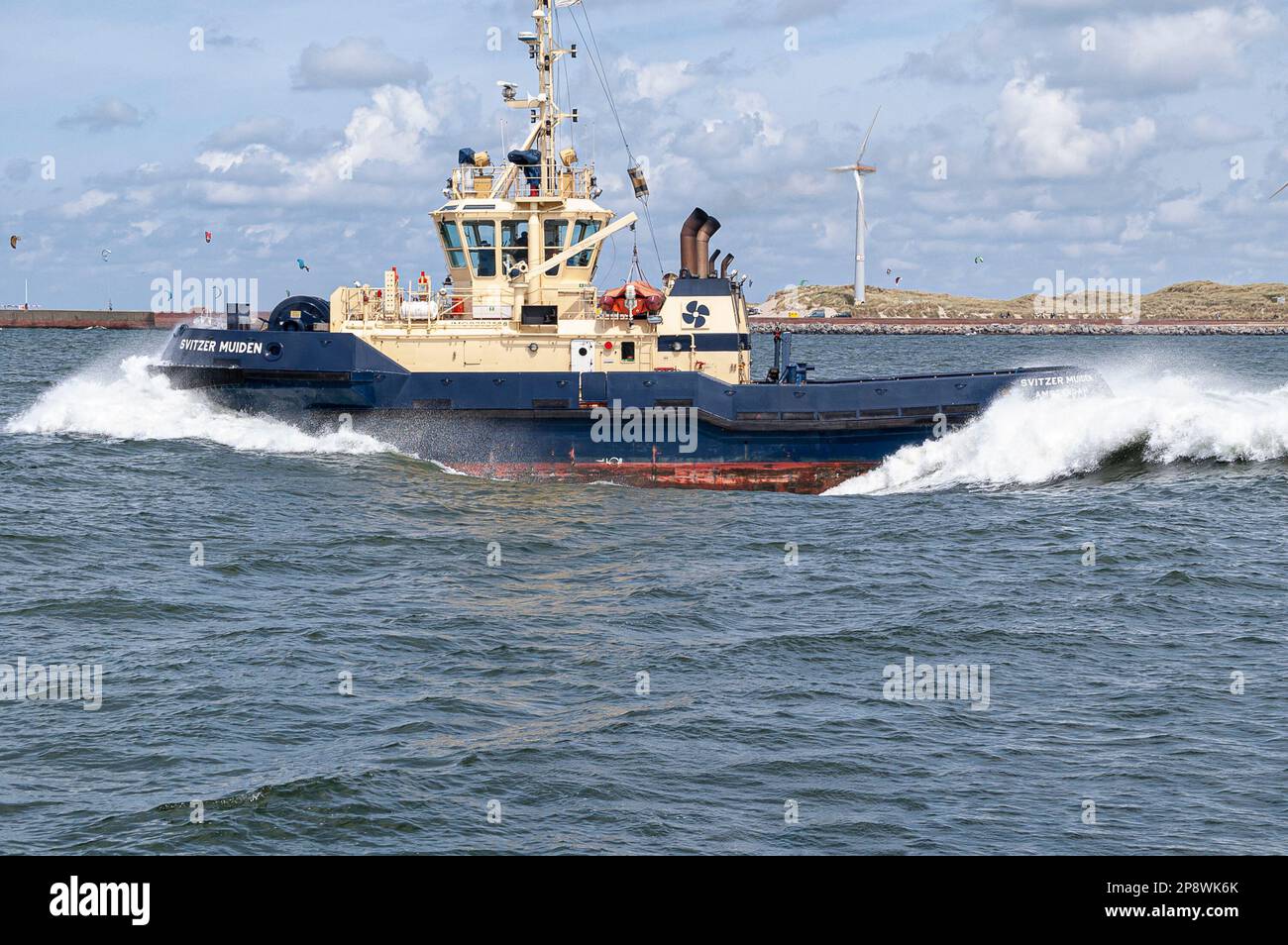 blue tugboat with yellow cabin sails across the canal at speed Stock ...