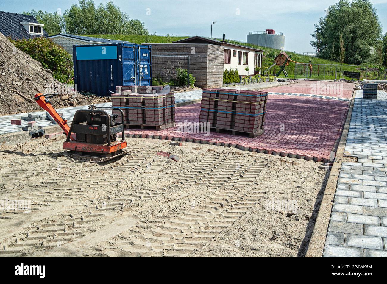 Vibrating machine on the sand at a construction site with paving stones ...