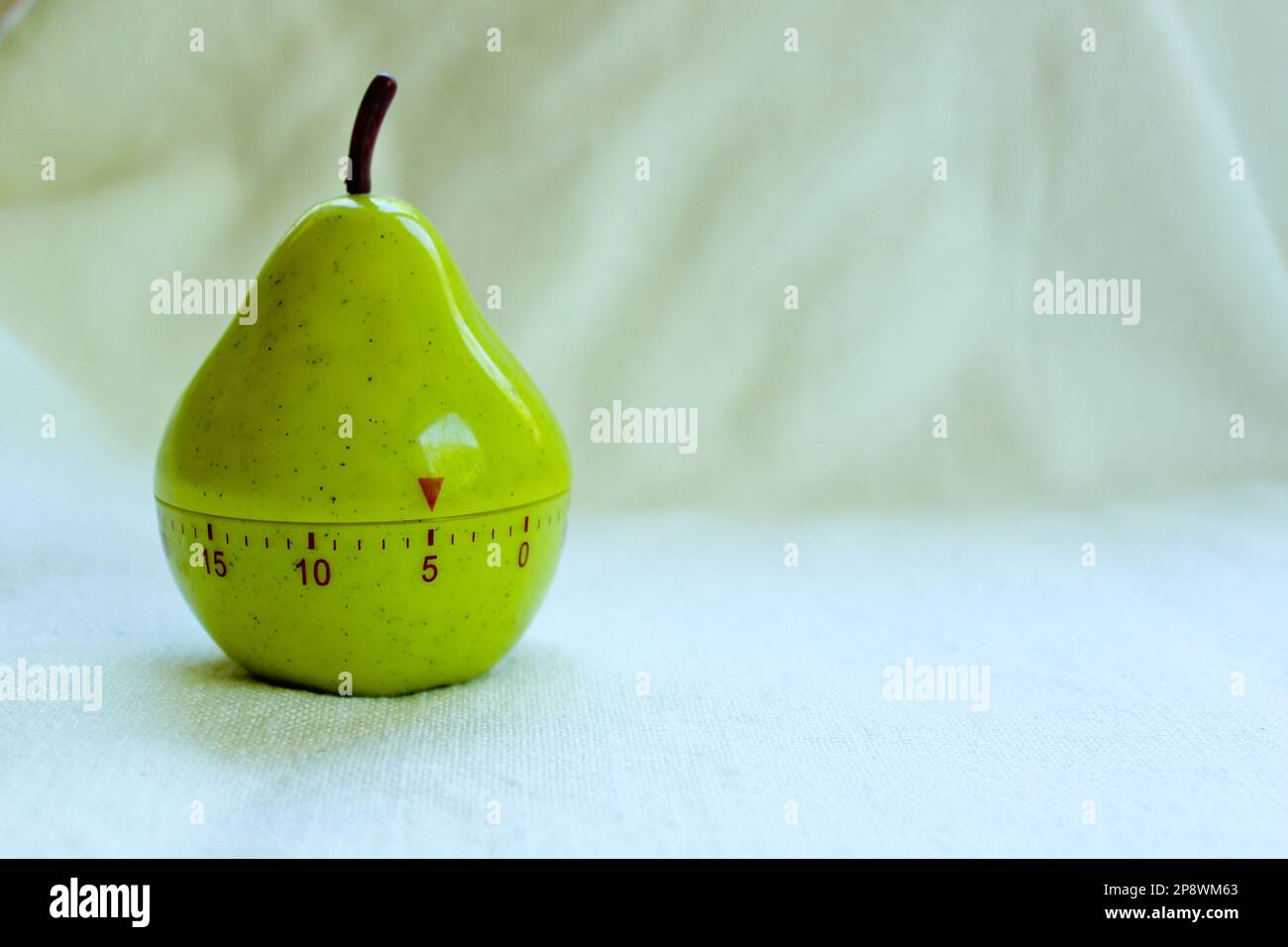 Kitchen egg timer in pear shape turned on 5 minutes isolated Stock ...