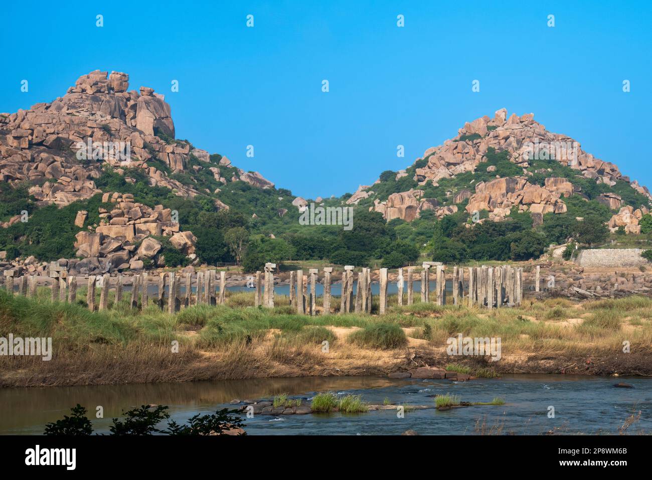 Stone pillars of the abandoned old bridge of Tungabhadra River, Hampi ...