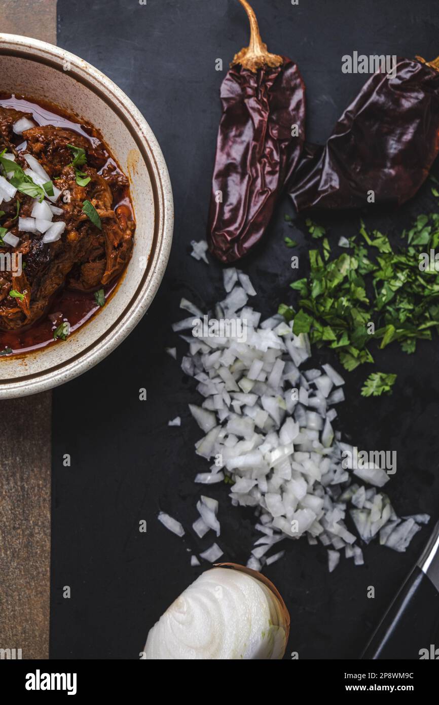A bowl of slow cooked and braised birria beef meat in a vintage bowl ...