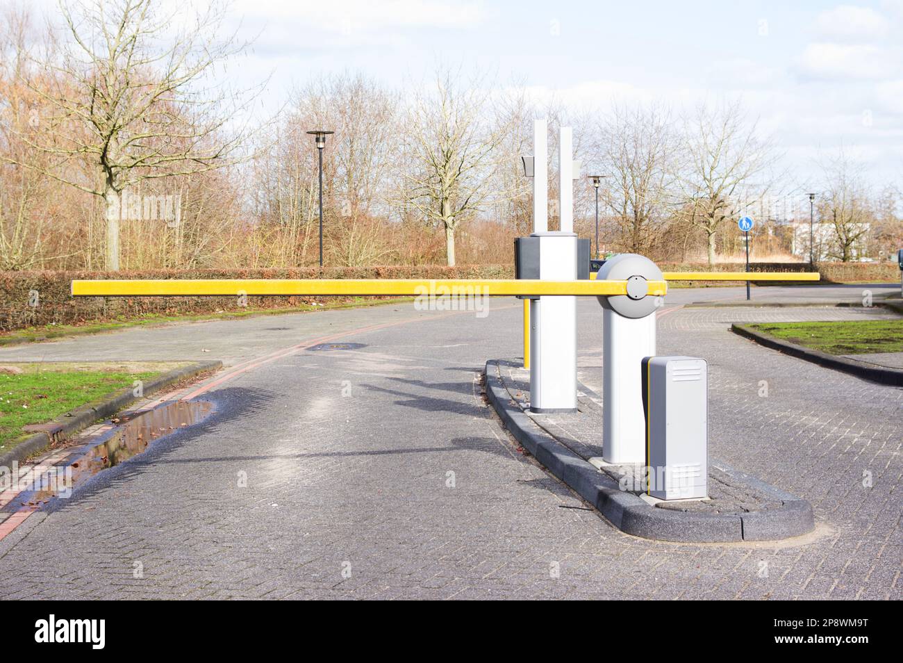Modern yellow barrier that is closed on a parking spot Stock Photo - Alamy