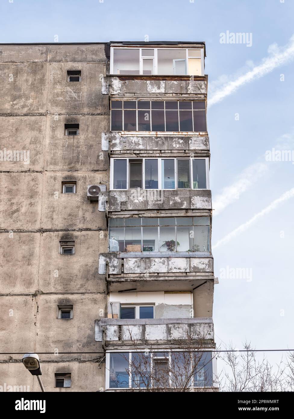 Worn out apartment building from the communist era against blue sky in ...